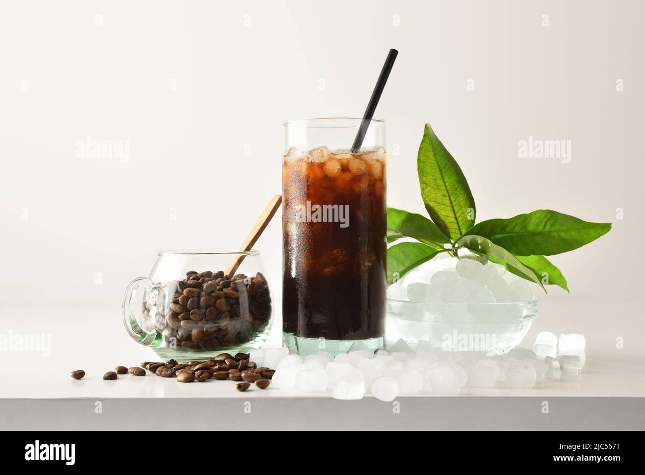 Coffee slush in tall glass with beans and crushed ice around it on ...
