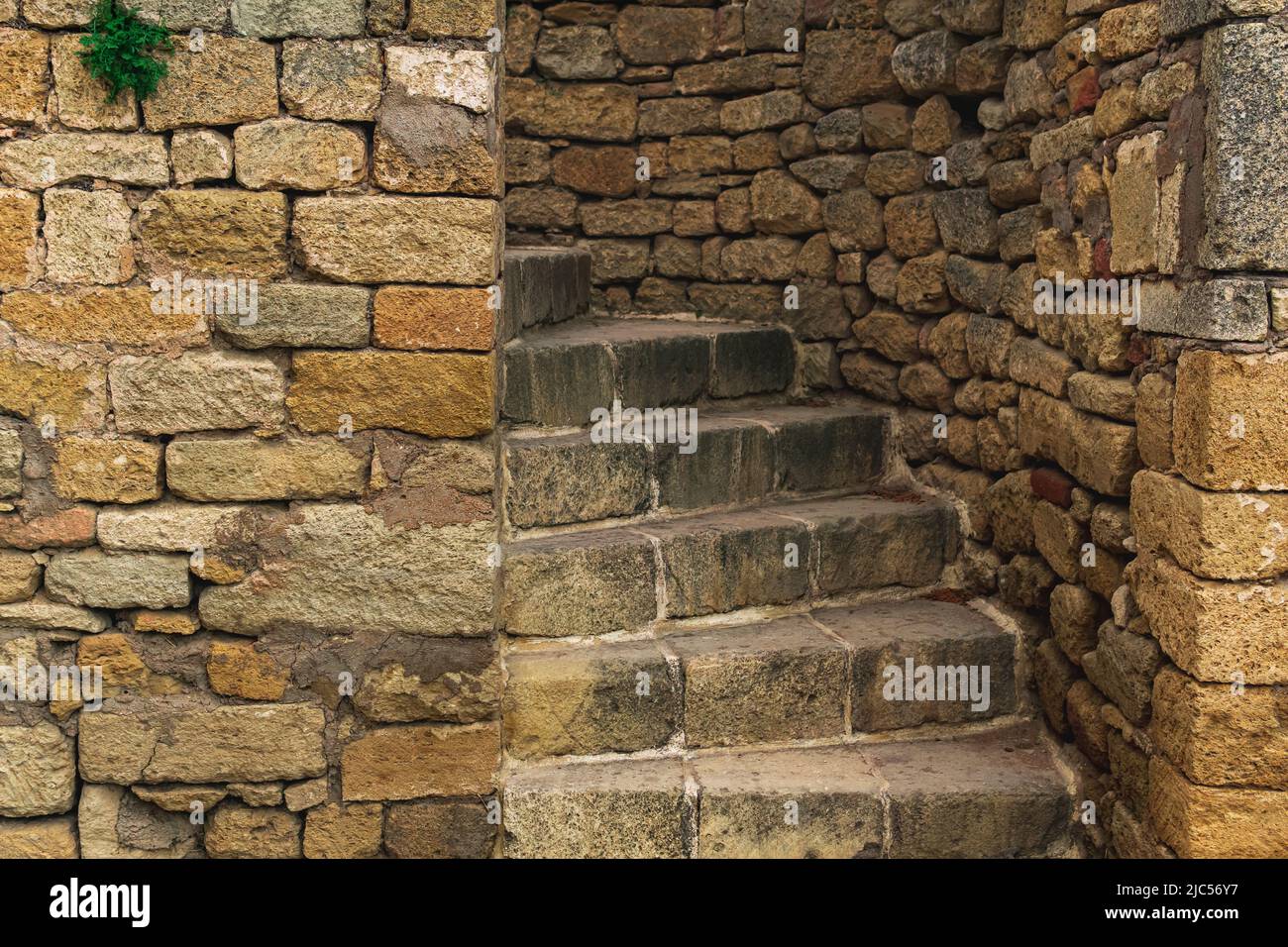 passage with a spiral staircase in an ancient stone wall Stock Photo ...