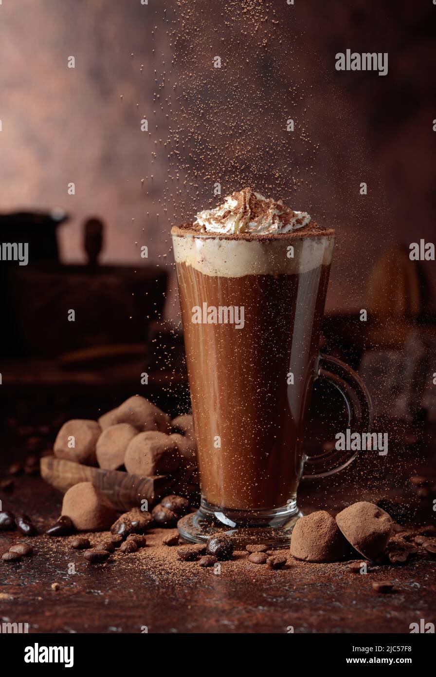 Truffles and glass of hot chocolate with whipped cream. Sweets and ...