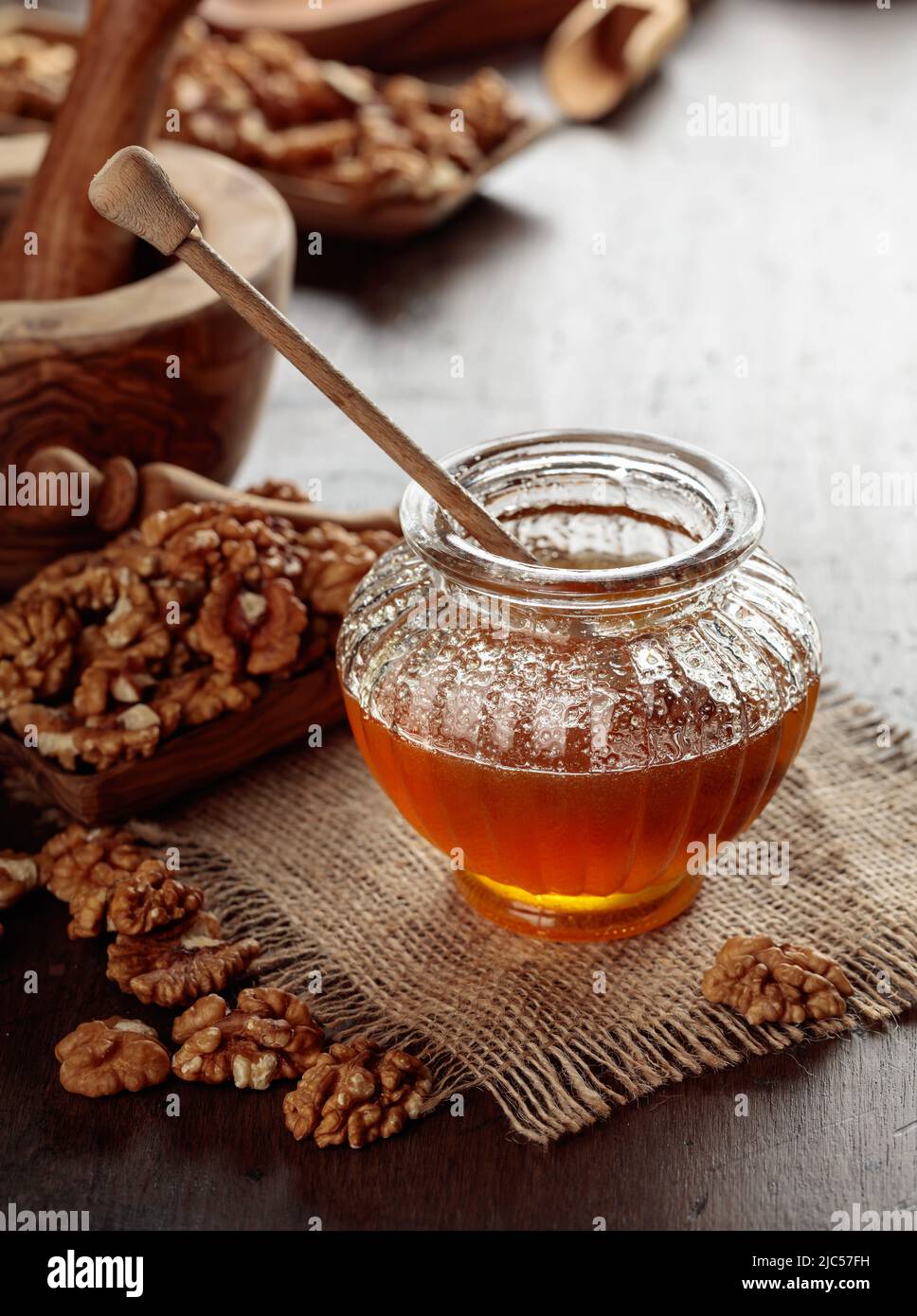 Honey and walnuts on a old wooden table Stock Photo - Alamy