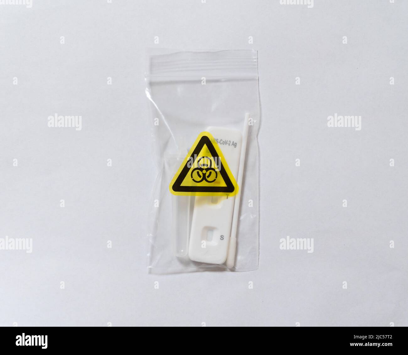 Covid antigen test kit placed in a biohazard waste bag after testing on ...
