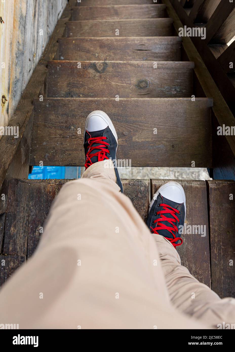 Man walking down the stairs wearing modern sneakers. Point of view. Top ...