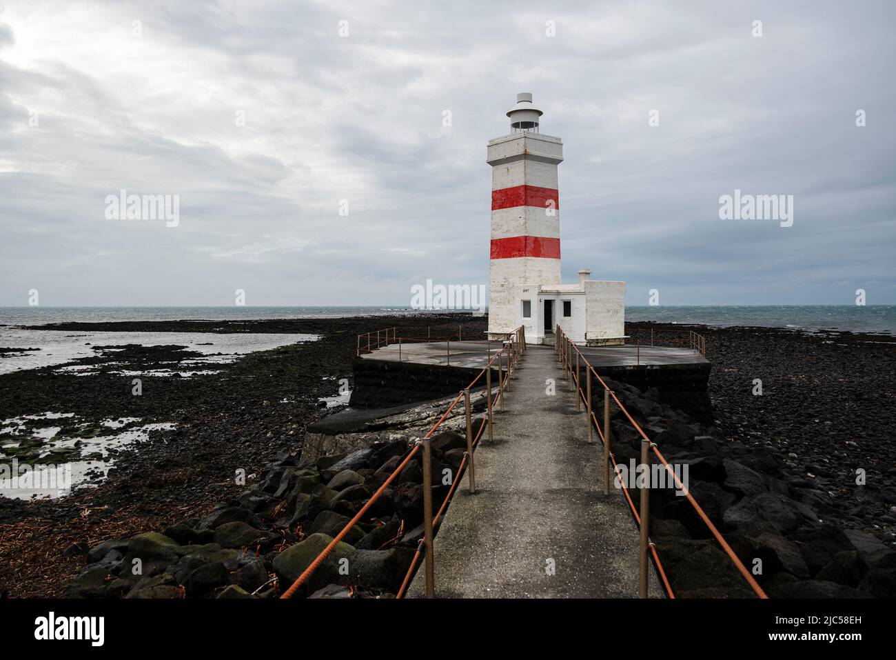 Scenic view of the old Garðskagi lighthouse in Garður under a cloudy ...