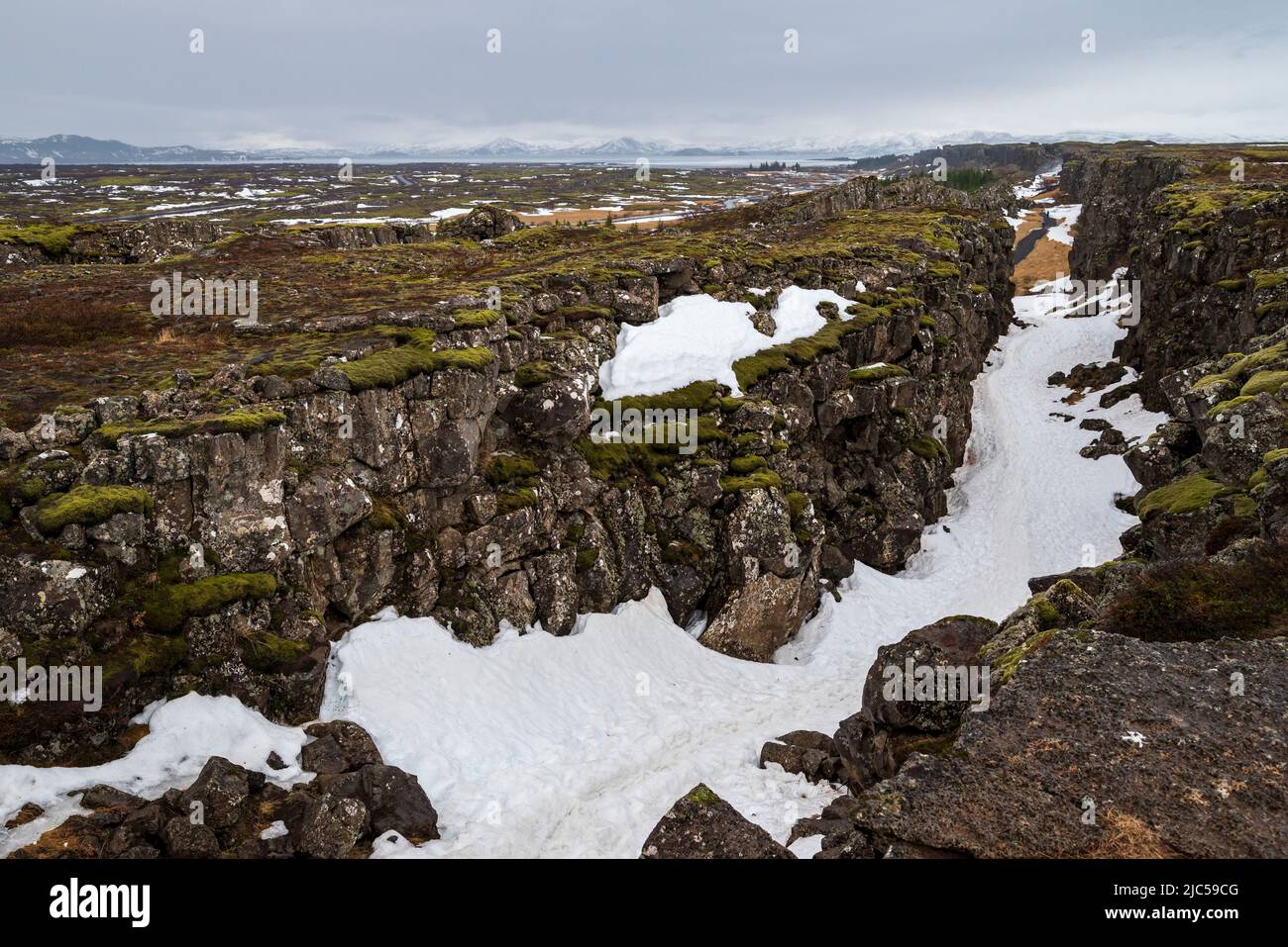 Elevated view of the snow-filled Almannagjá Gorge in late winter ...