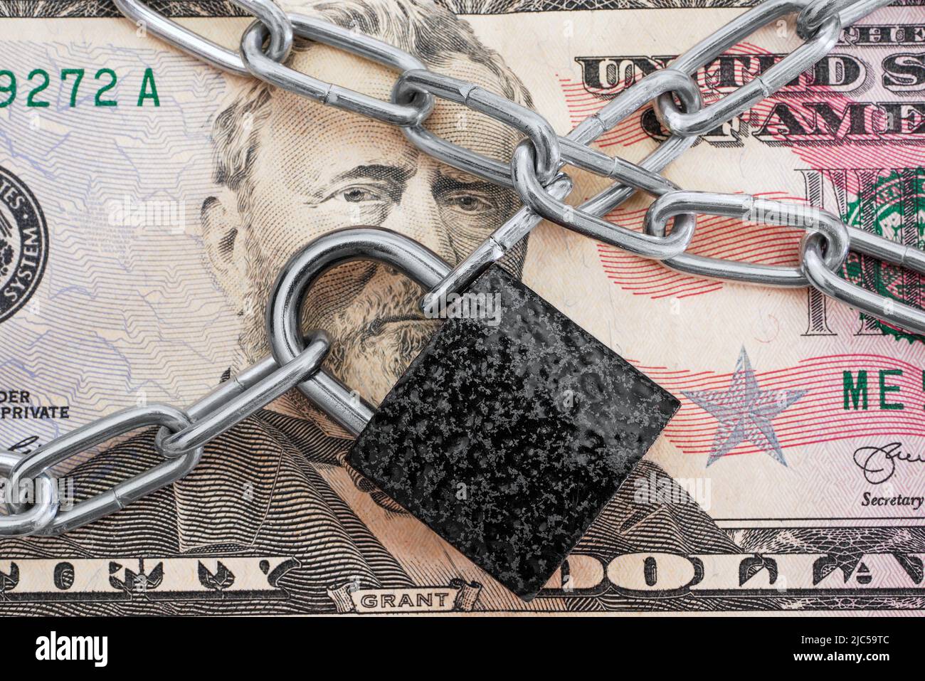 closeup of dollar banknote criss-crossed by chain with padlock Stock ...