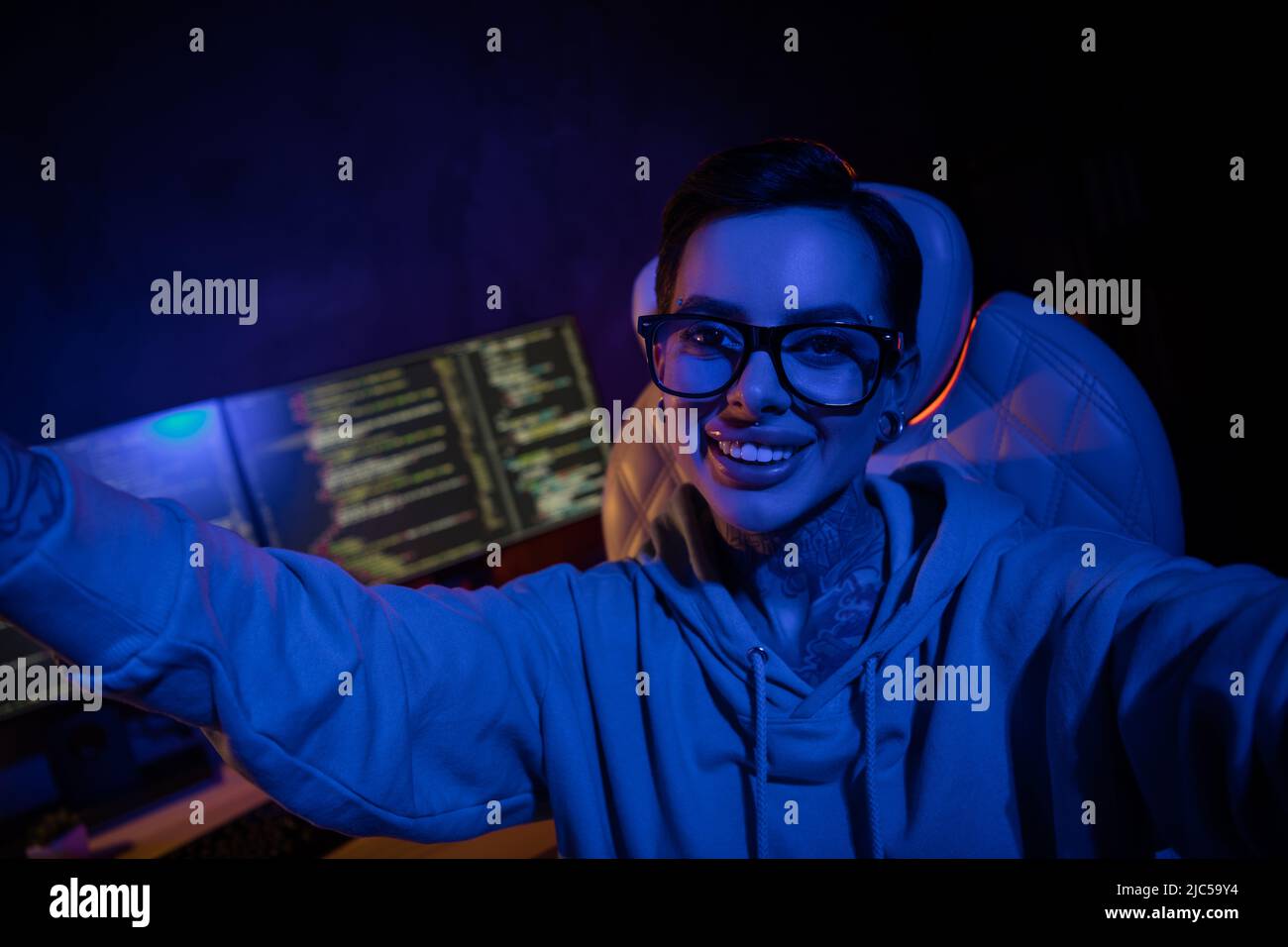 Photo of positive happy programmer make selfie recording video sitting chair operating database ...