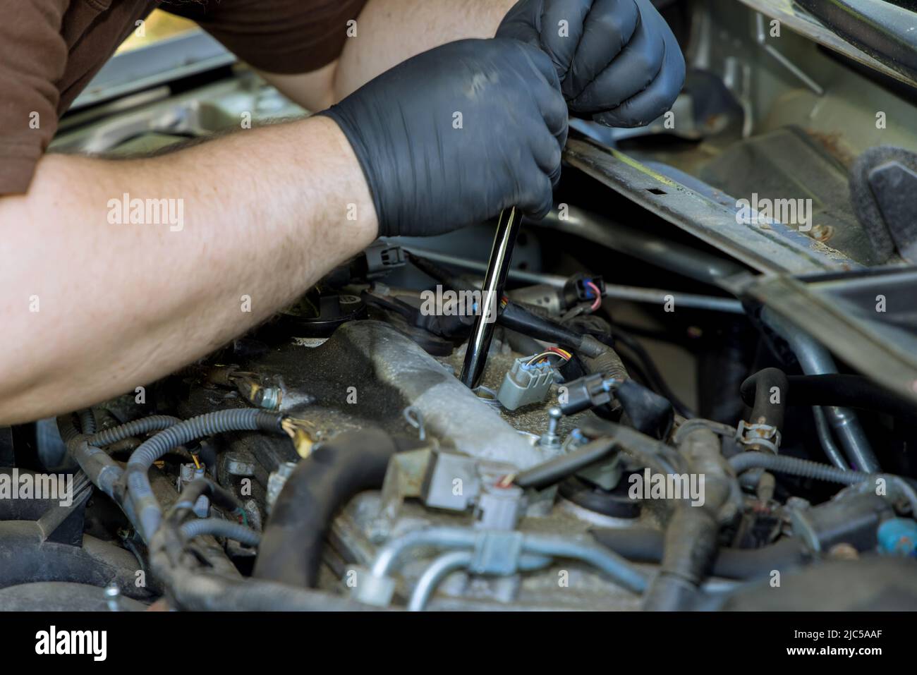 Emergency repair of a car on replacement on a car spark Stock Photo - Alamy