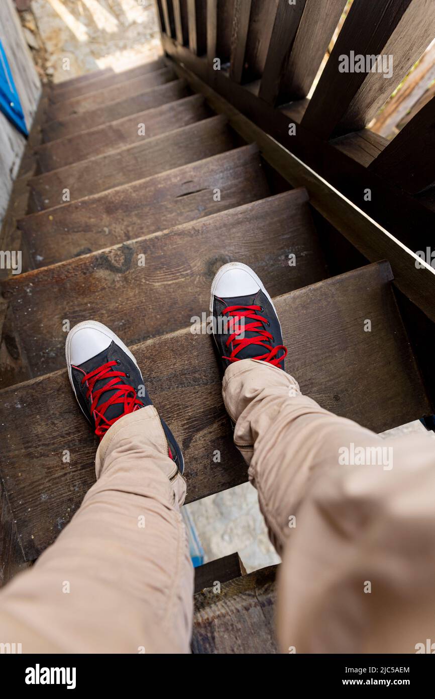 Man walking down the stairs wearing modern sneakers. Point of view. Top ...