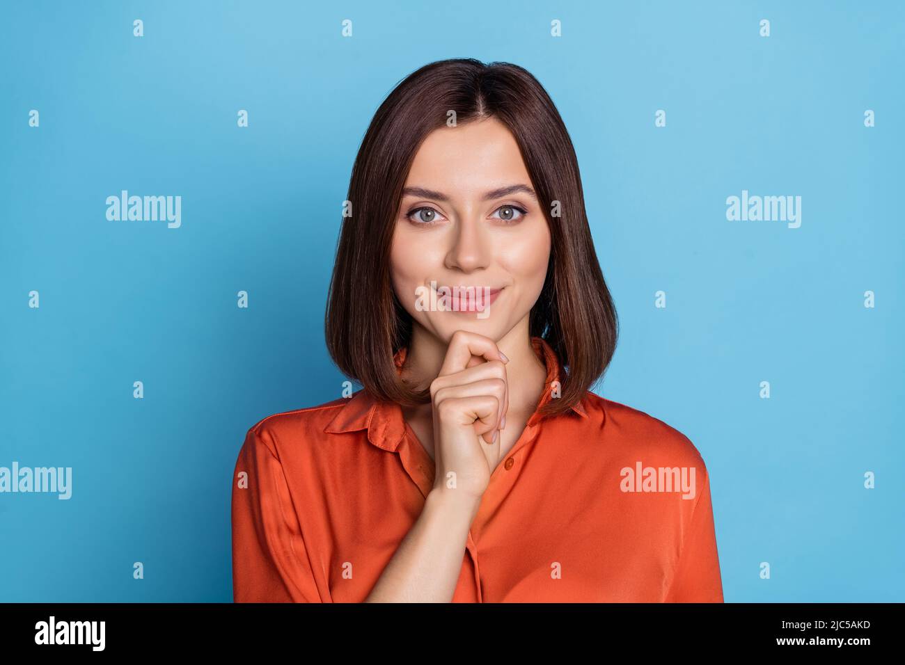 Portrait of attractive cheerful girl making decision touching chin ...