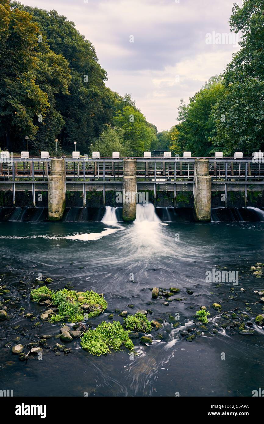 A water barrier during spring time with green trees in Osnabrück ...