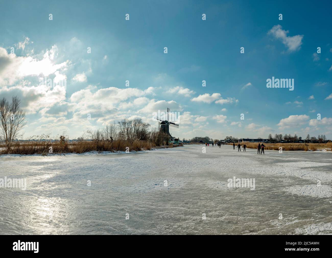 Scating on a frozen canal near a windmill *** Local Caption ...