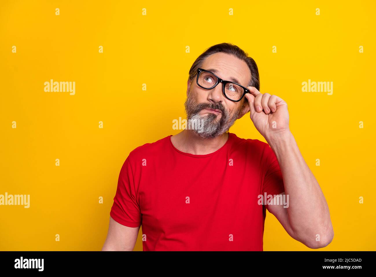 Photo of senior man hand touch eyeglasses look empty space thoughtful ...