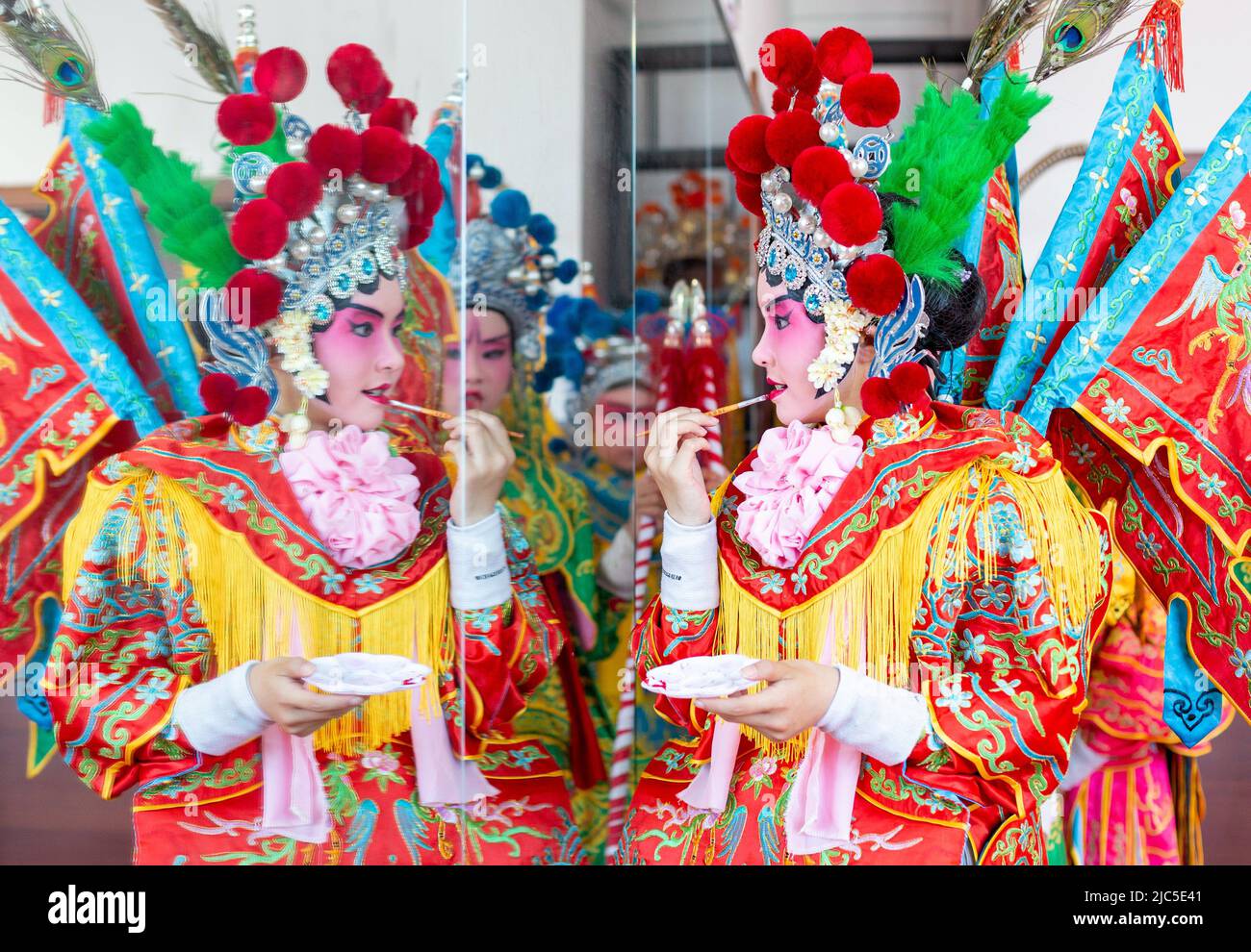 HAIAN, CHINA - JUNE 10, 2022 - Children learn Peking Opera makeup at a ...