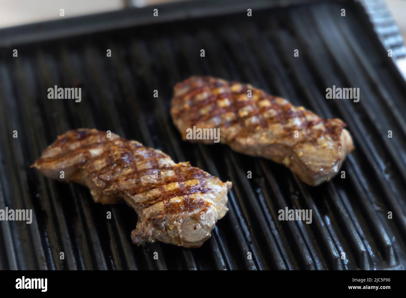 Electric grill with roast beef Stock Photo - Alamy