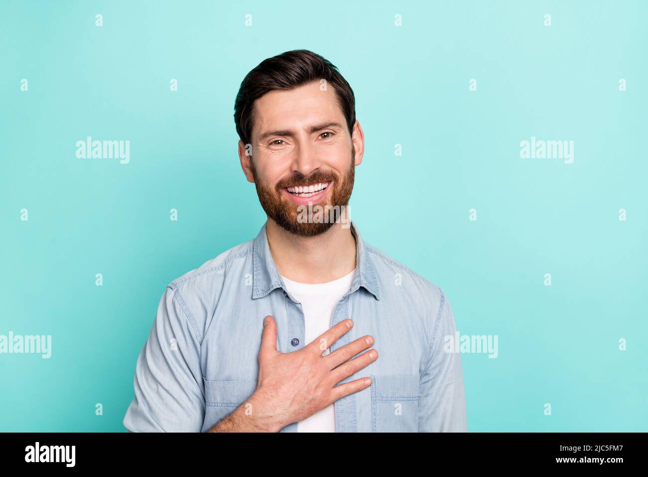 Photo of optimistic guy put hands chest feel grateful thankful charity isolated on cyan color ...