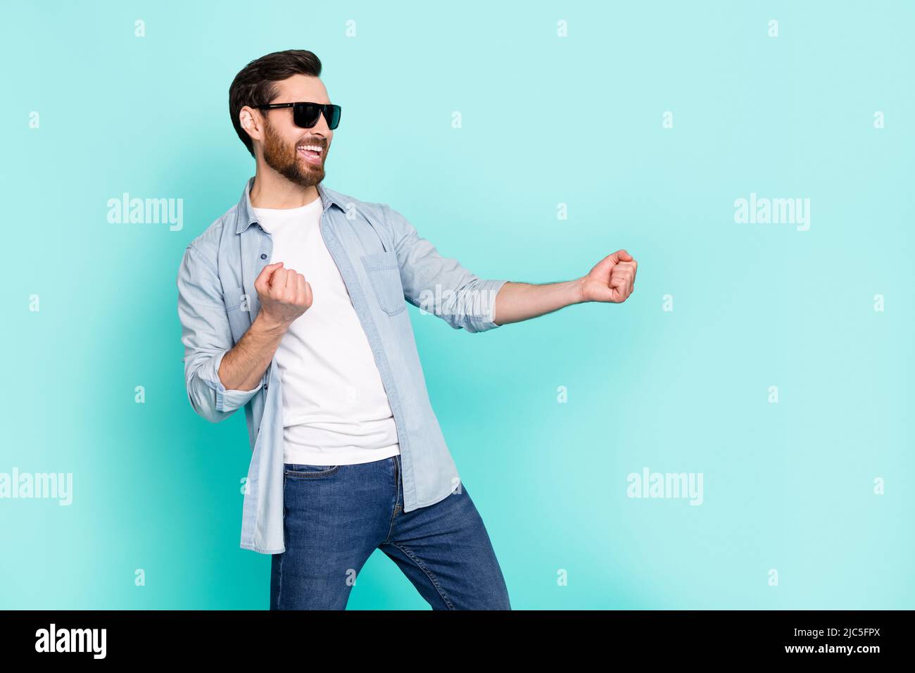 Photo of positive overjoyed guy have good mood raise fists enjoy ...