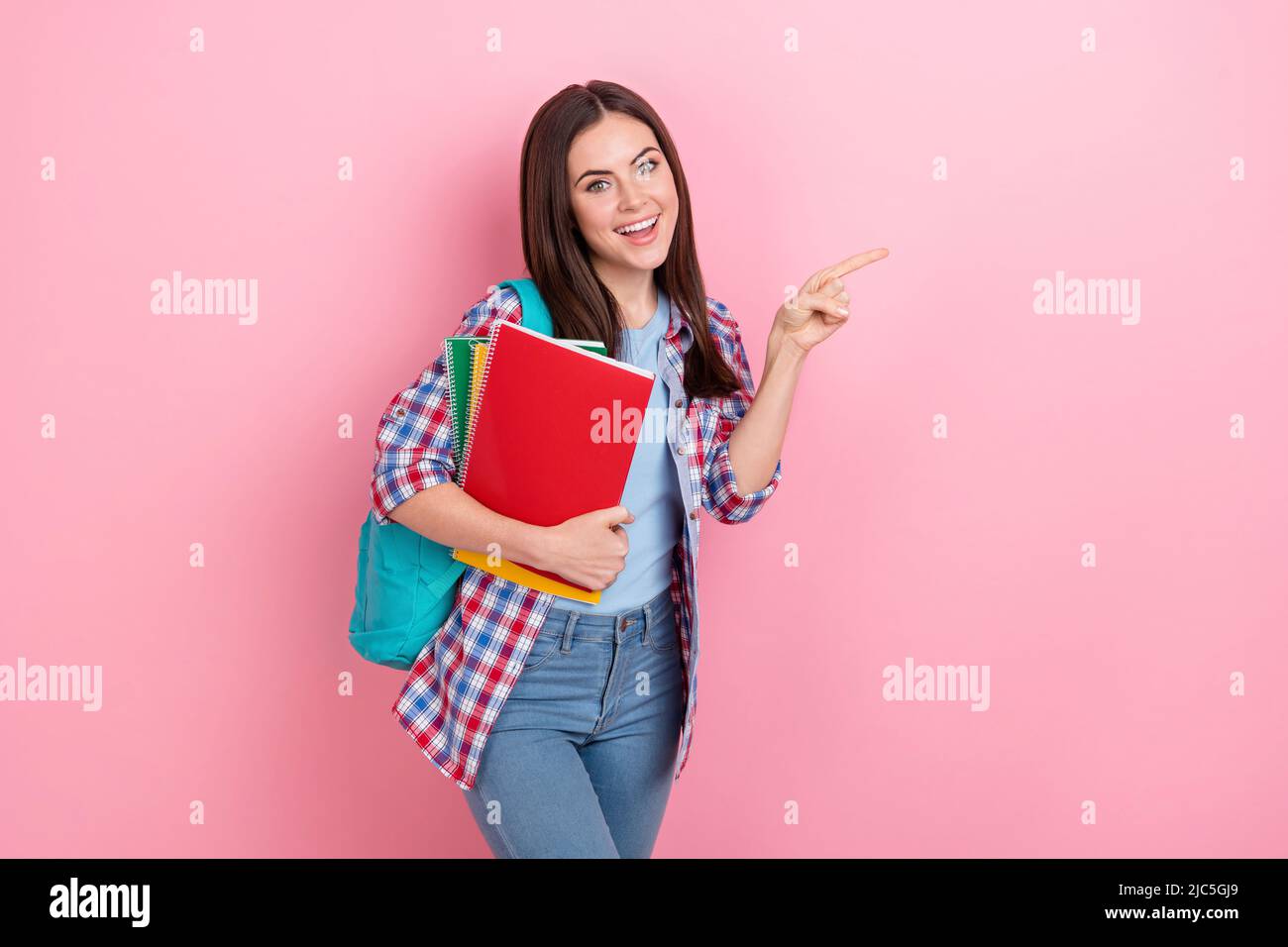 Photo of smiling pretty girl studying in college point finger empty ...