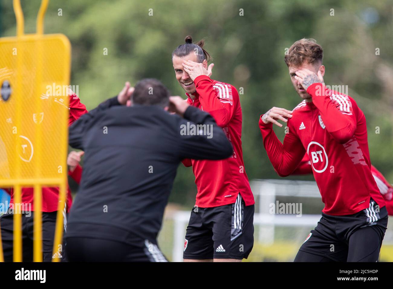 Hensol, Wales, UK. 10th June, 2022. Gareth Bale and Joe Rodon touch ...