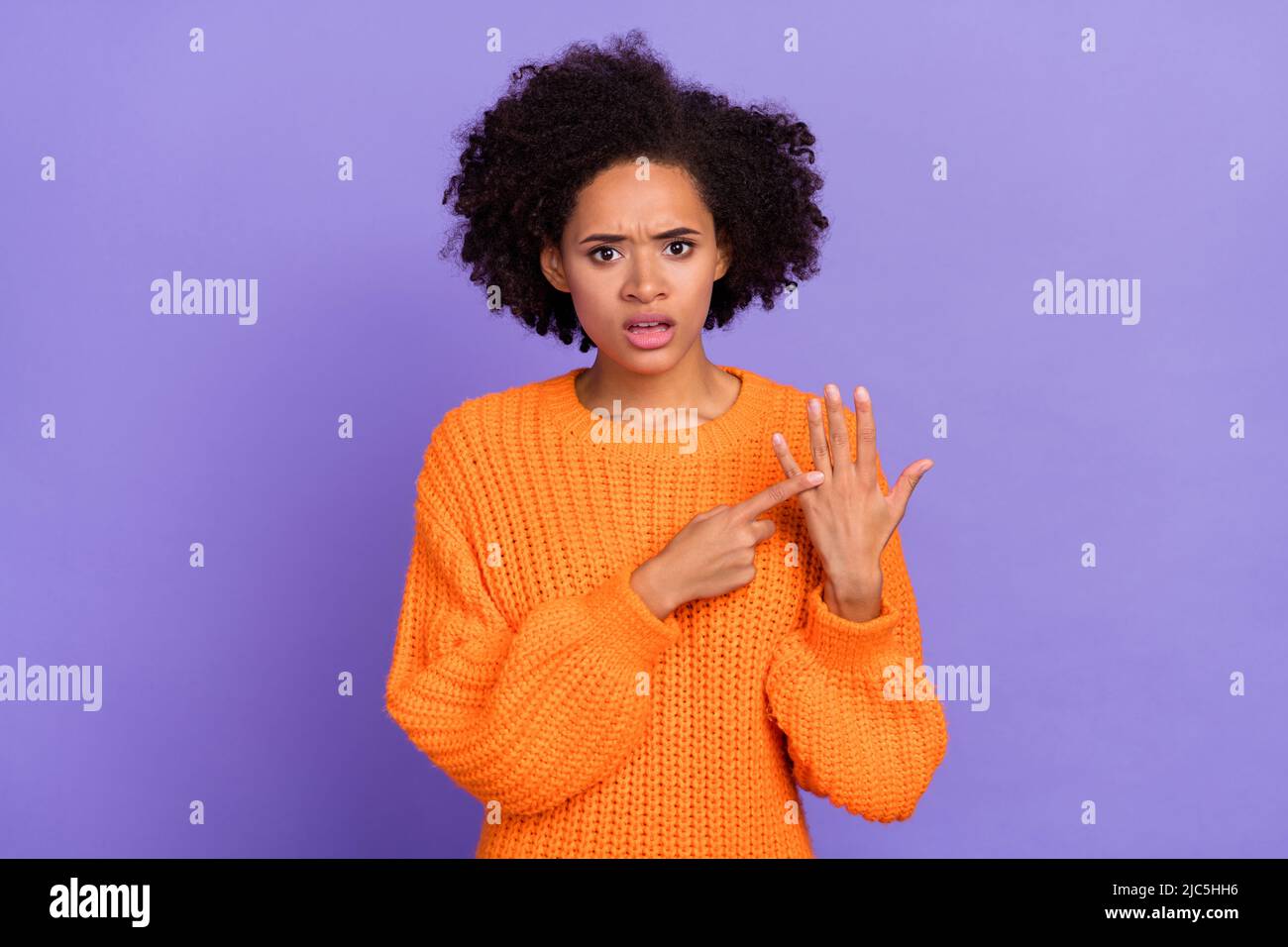 Portrait of attractive desperate girl showing empty finger no wedding ring isolated over bright ...