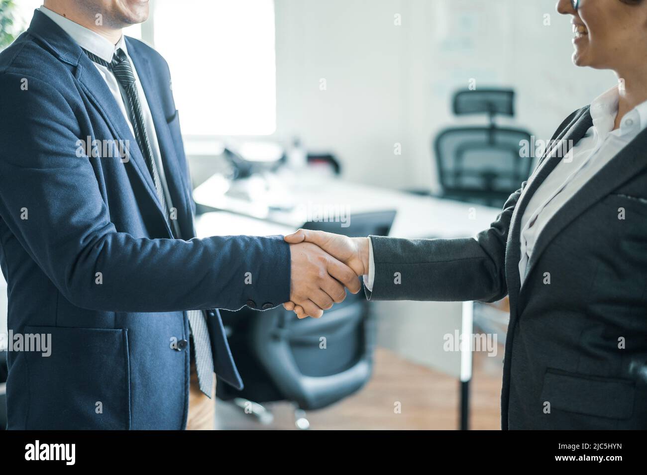 Handshake business man and woman at the conclusion of a successful ...