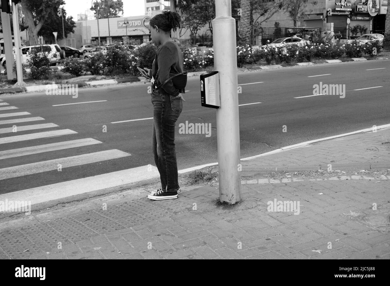 Woman standing road in Black and White Stock Photos & Images - Alamy