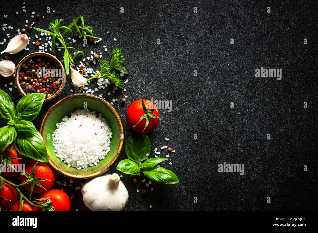 Food cooking background on black stone table Stock Photo - Alamy