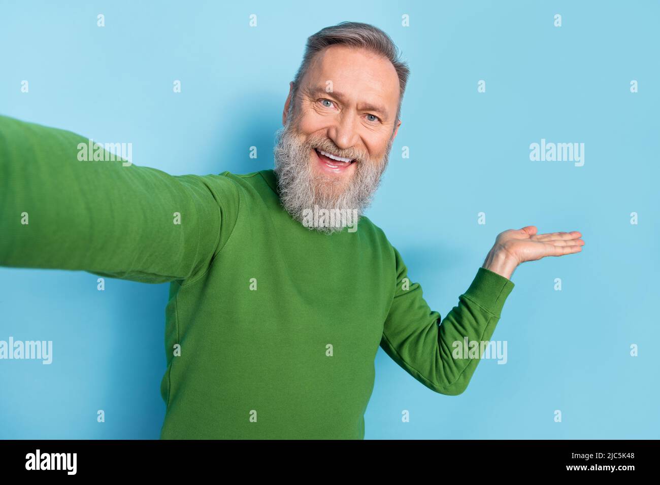 Photo of positive funky middle aged man making selfie hold palm ...