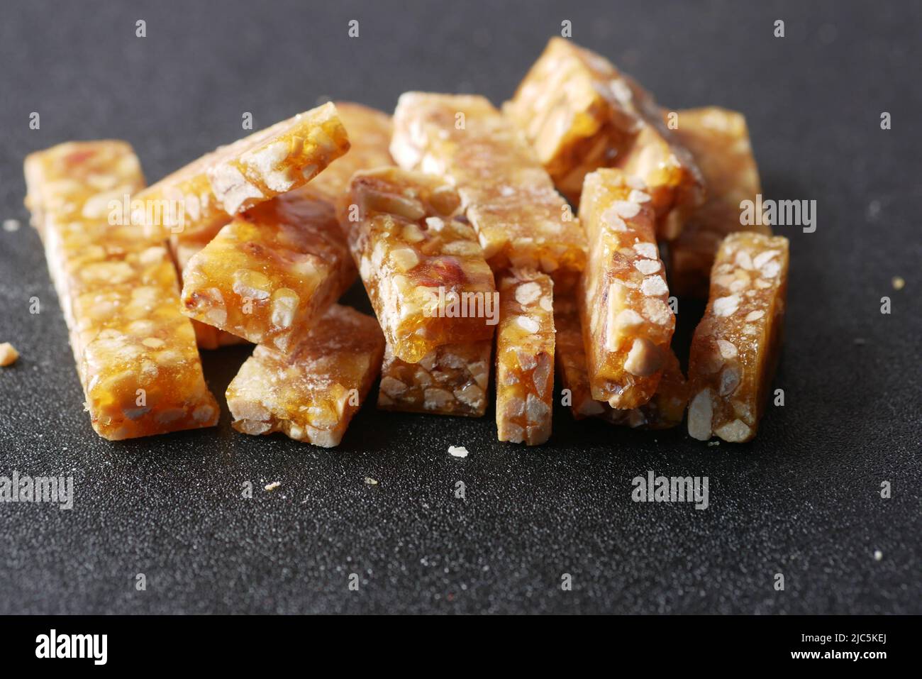 pea nuts sweet bar black background close up Stock Photo - Alamy