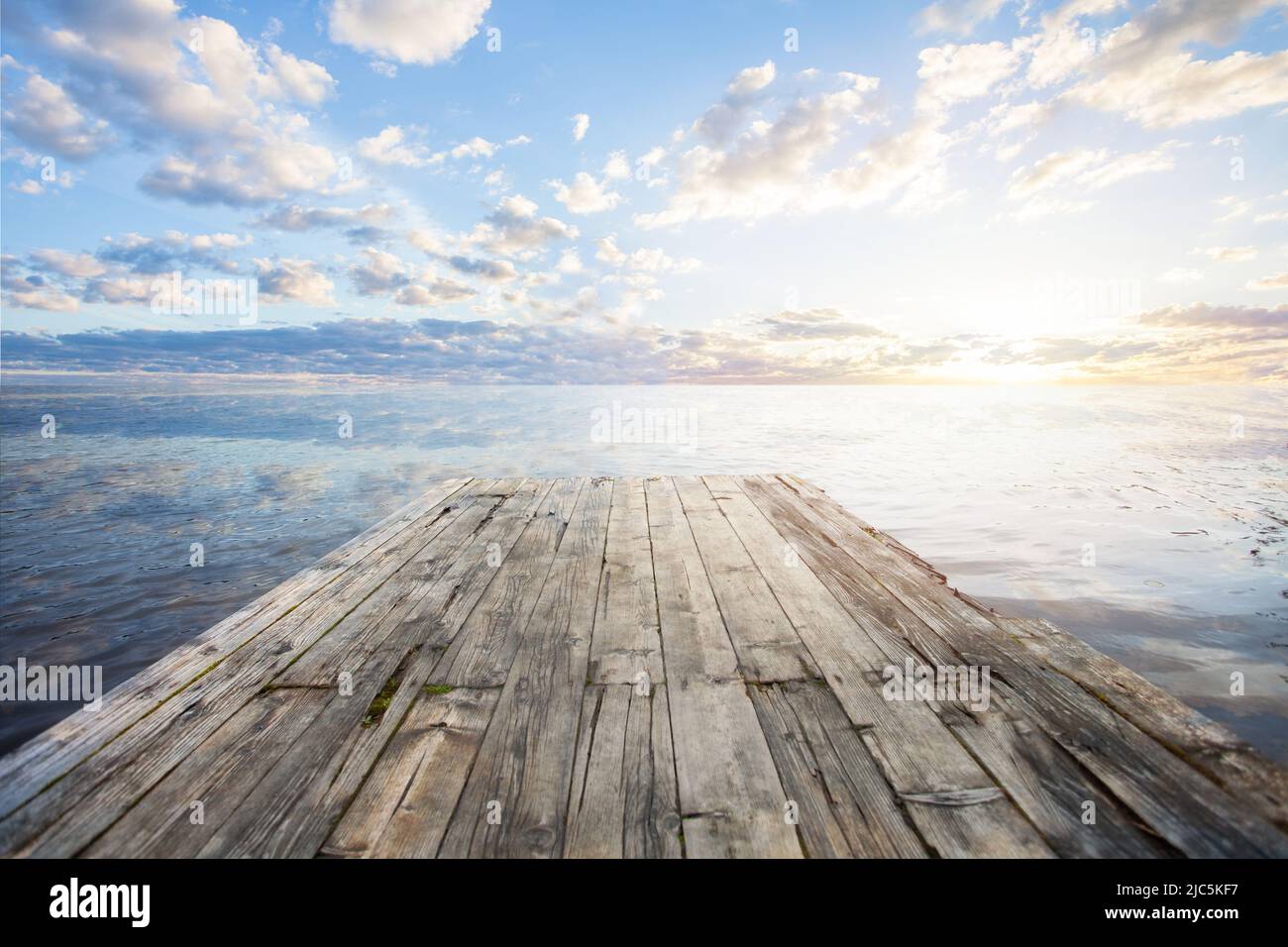 Empty wooden jetty at sunset, looking out over water Stock Photo - Alamy