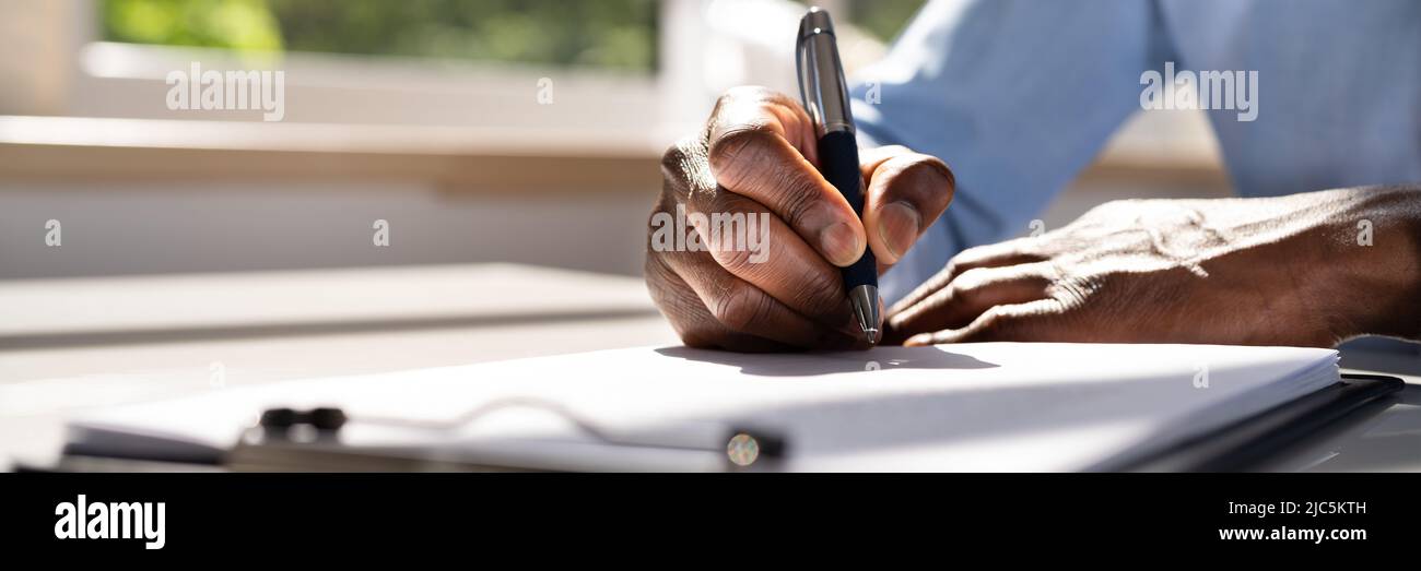 Close-up Of Businessman's Hand Signing On Papers Over Desk Stock Photo ...