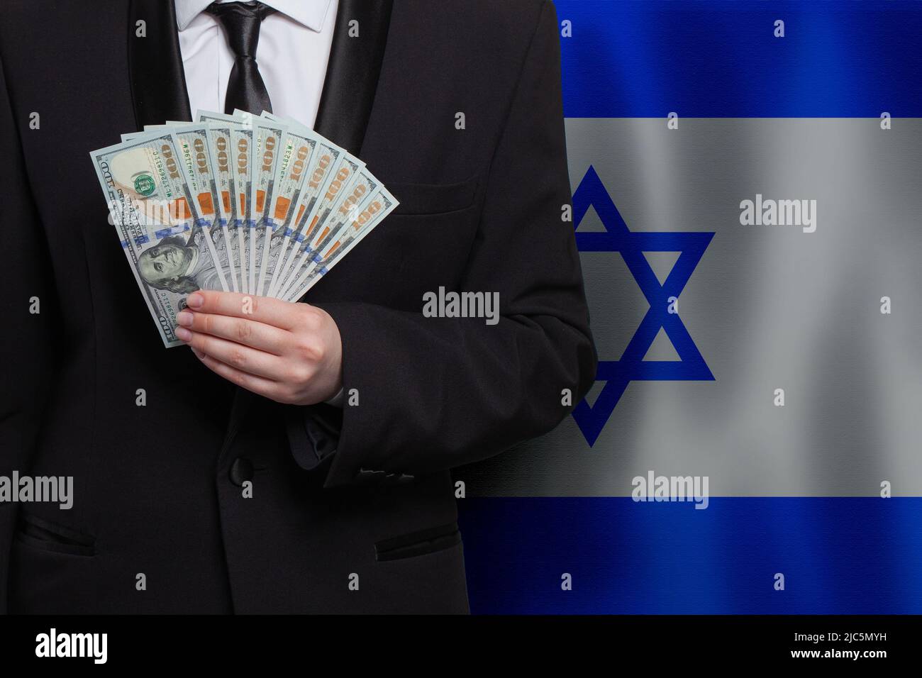 Israeli business man with US 100 dollar bills against flag of Israel ...