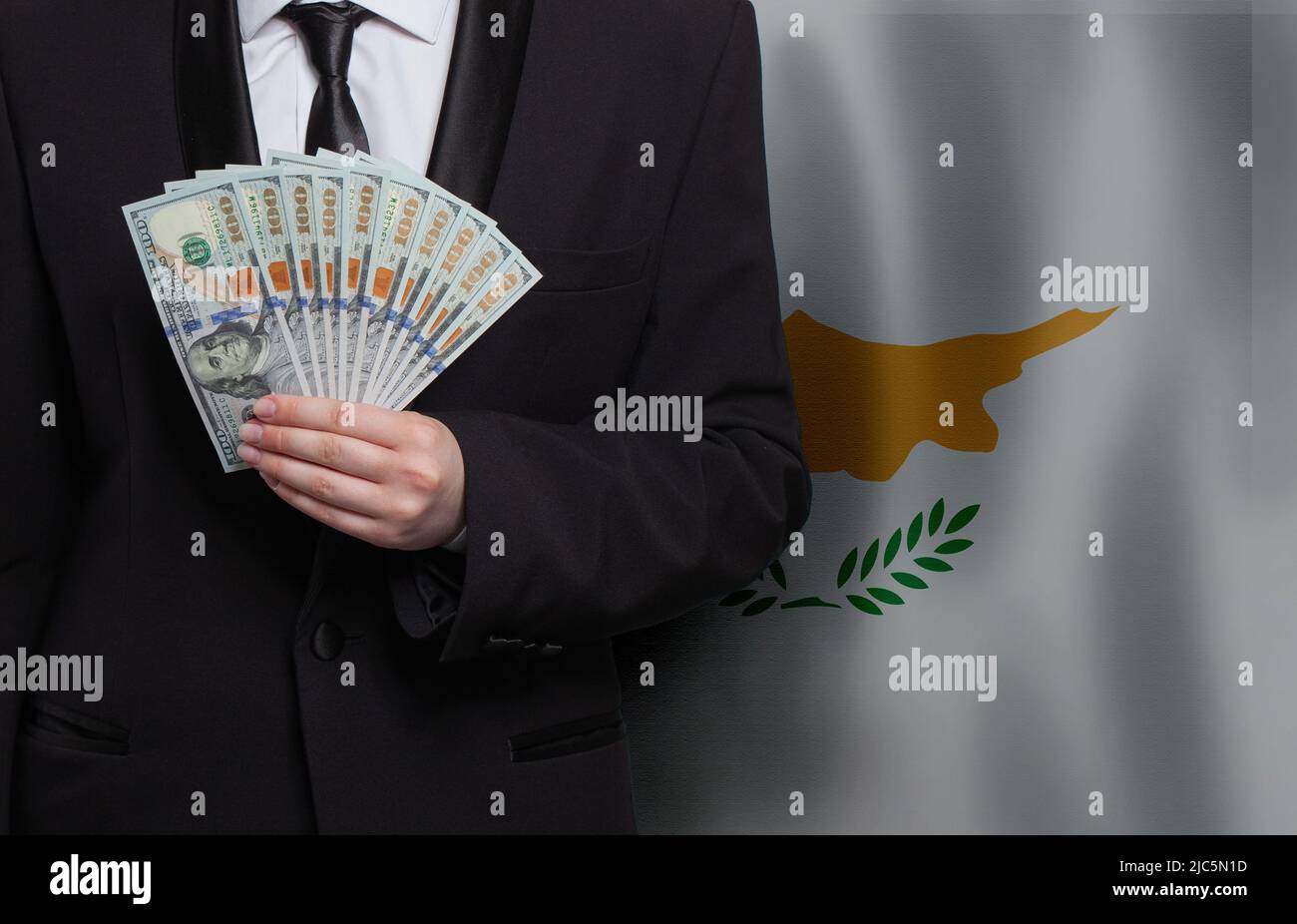Cypriot business man showing 100 US dollar bills against flag of ...