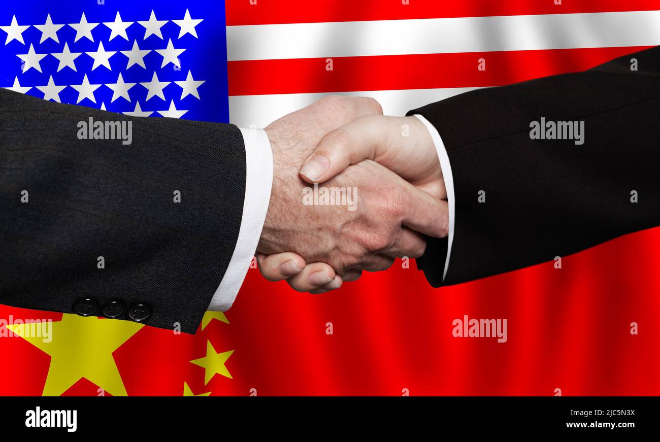 Handshake against USA and China flags background Stock Photo - Alamy