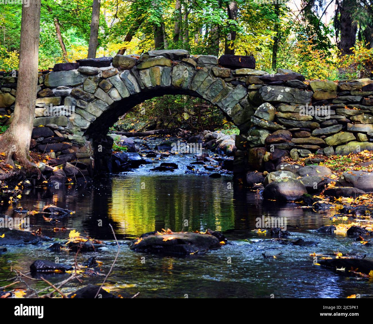 Stone bridge over water in autumn Stock Photo - Alamy