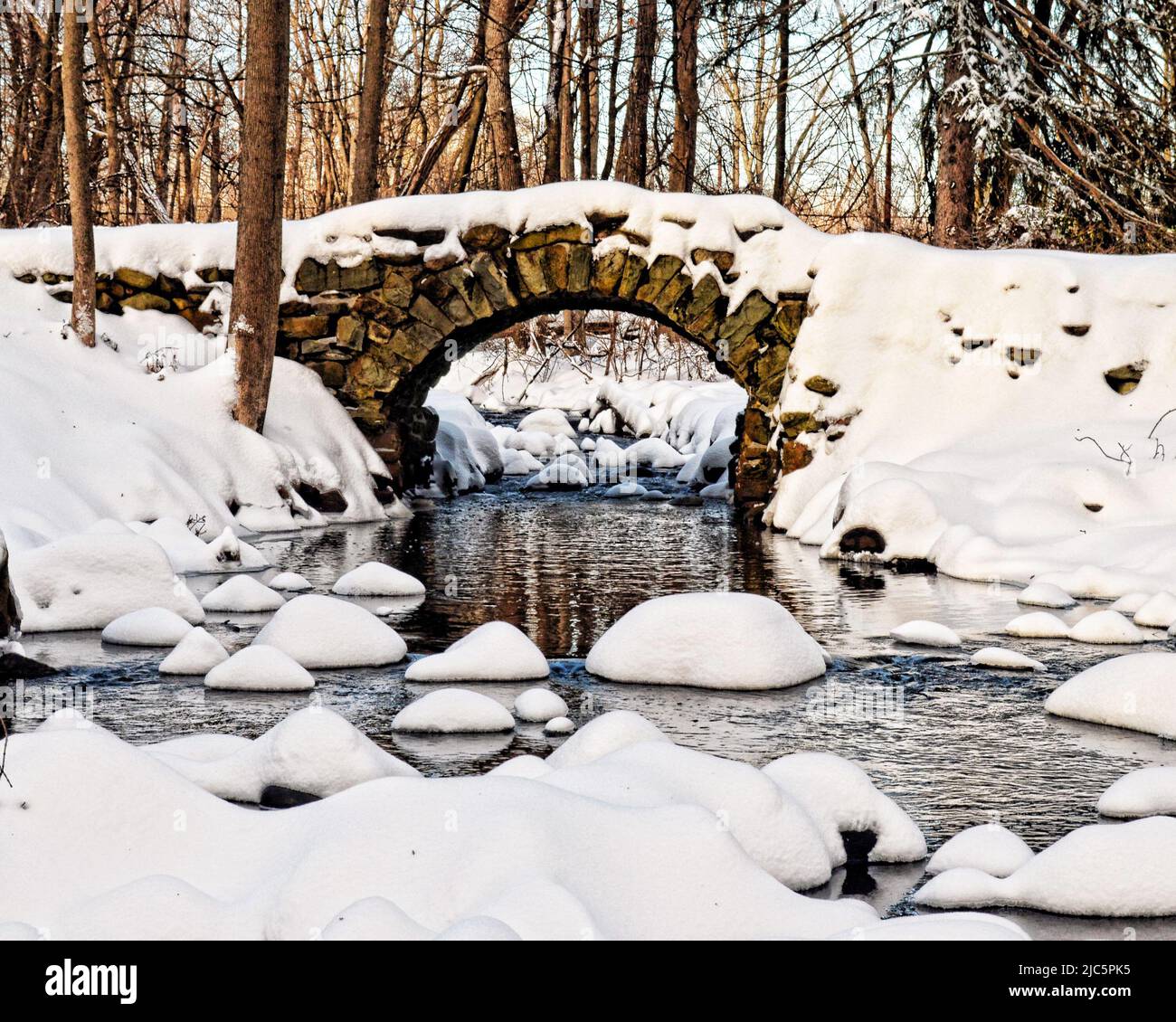 Stone bridge over water in the snow Stock Photo - Alamy