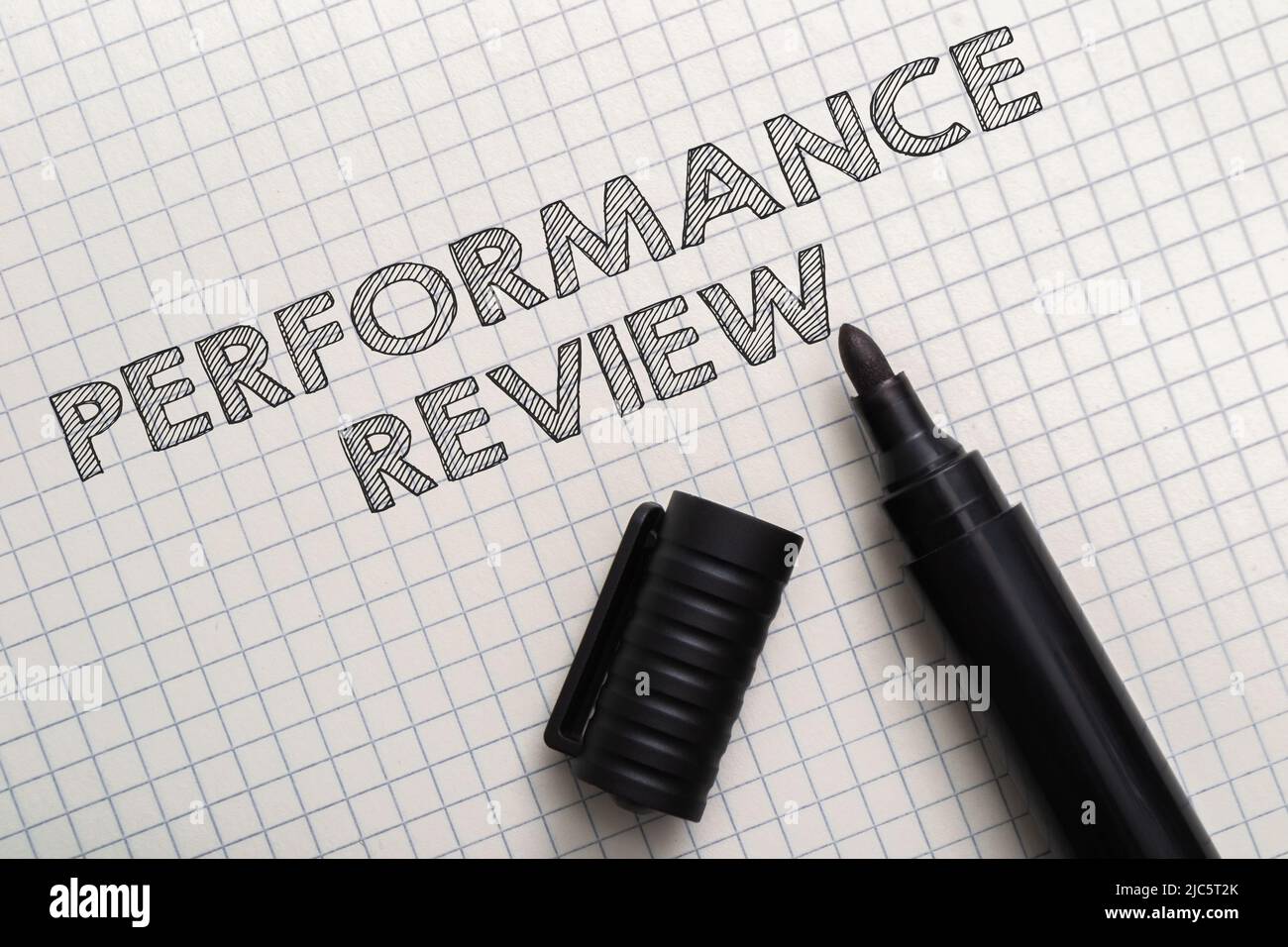 Words Performance Review and open marker on checkered paper Stock Photo ...