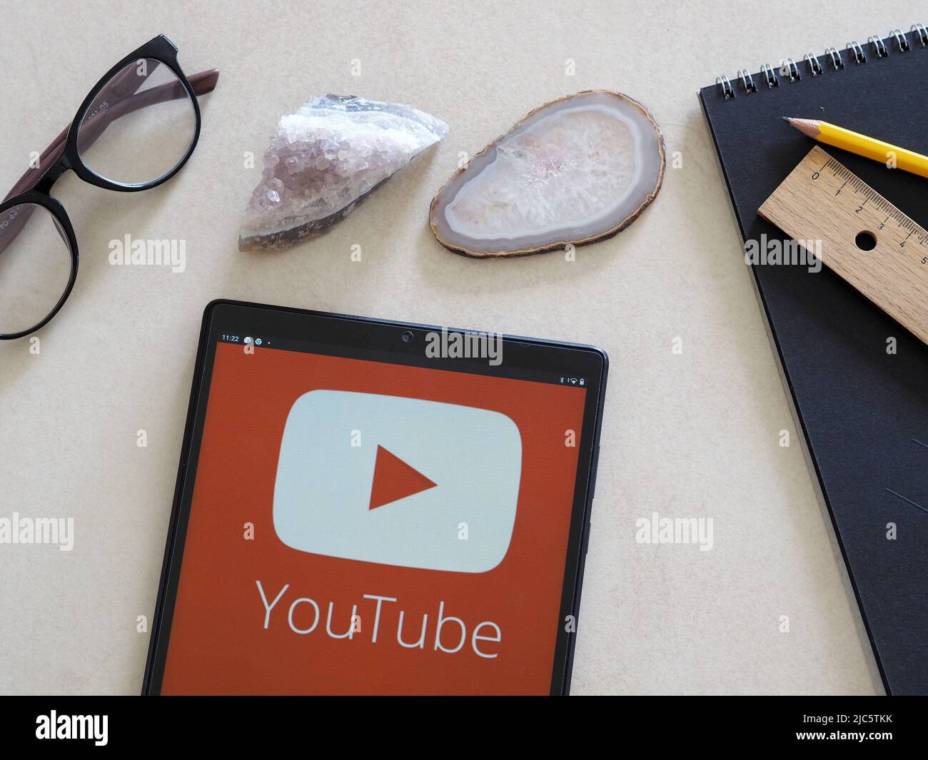 In this photo illustration YouTube logo seen displayed on a tablet ...
