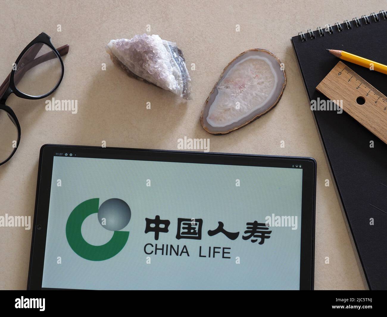 In this photo illustration China Life logo seen displayed on a tablet ...