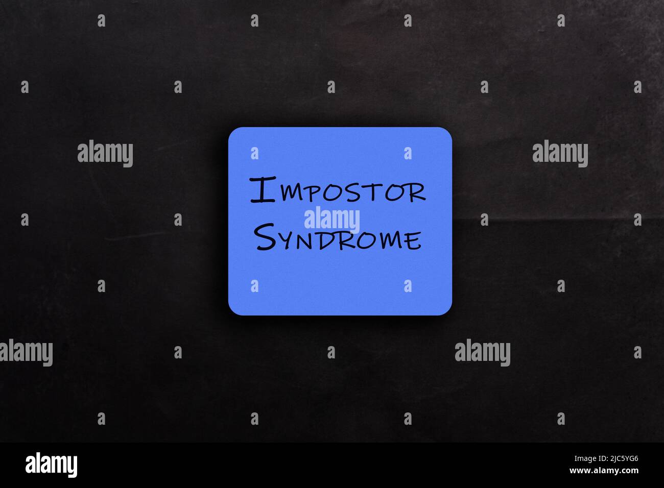 Blue card with words Impostor Syndrome on black background Stock Photo ...