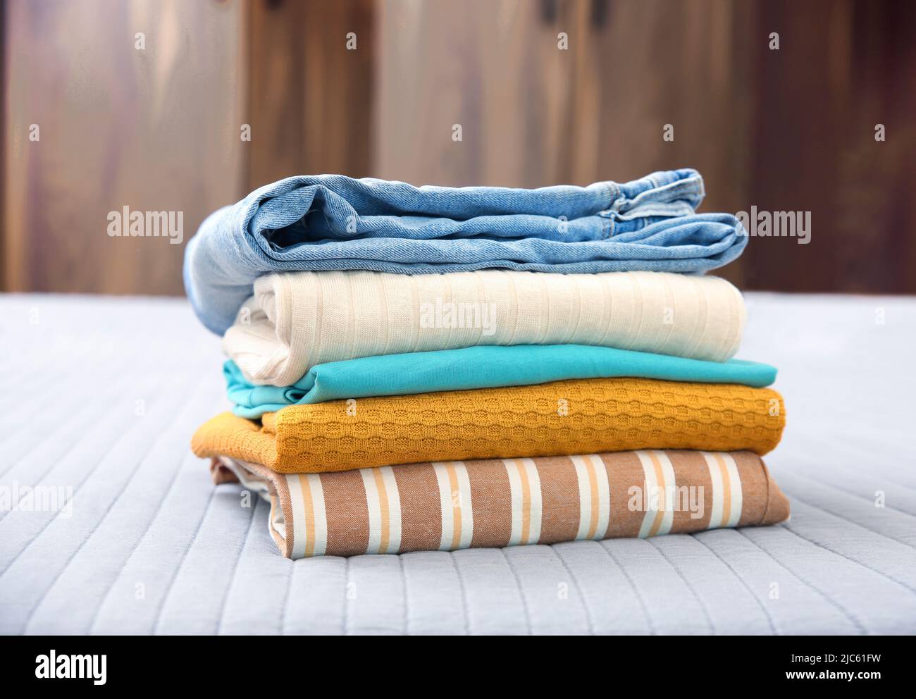 Stack of clothes. Pile of cotton garment.Folded clothing closeup ...