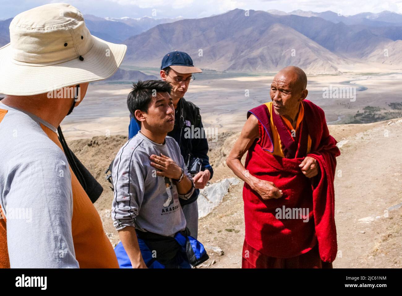 A Tibetan guide translate to the group what the lama has shared about ...