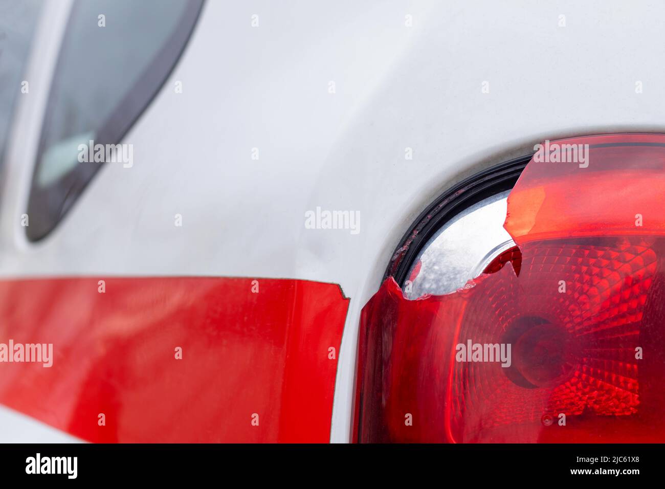 The rear left lamp of a white car is broken. The taillight of the car ...