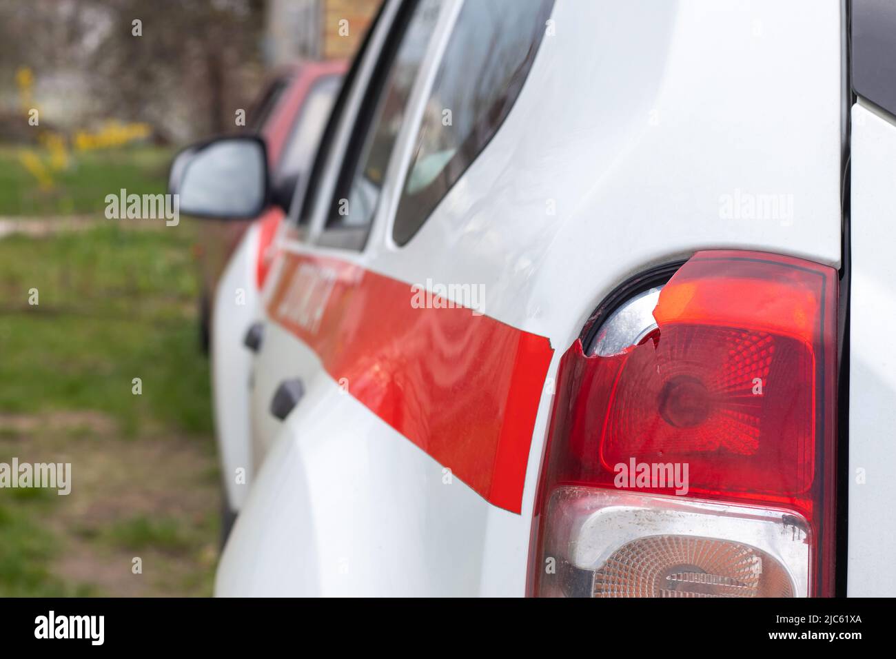 The rear left lamp of a white car is broken. The taillight of the car ...