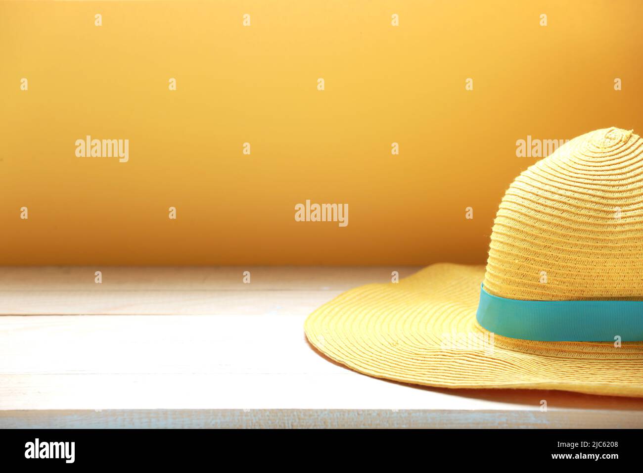 Summer background.Yellow beach hat on wooden table empty space backdrop ...