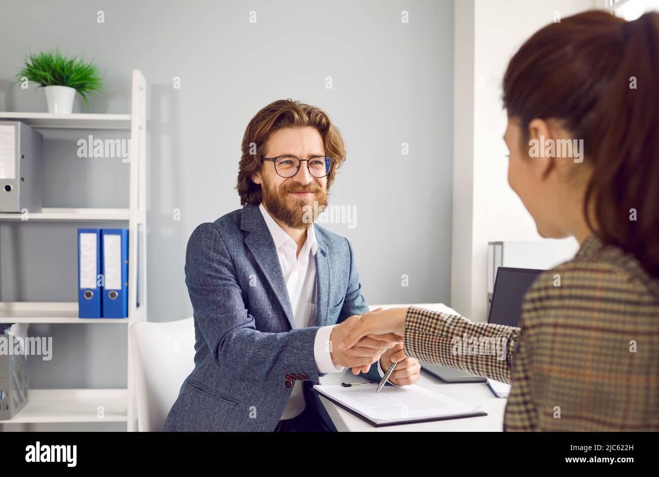 Friendly hr manager greeting candidate on interview hi-res stock ...