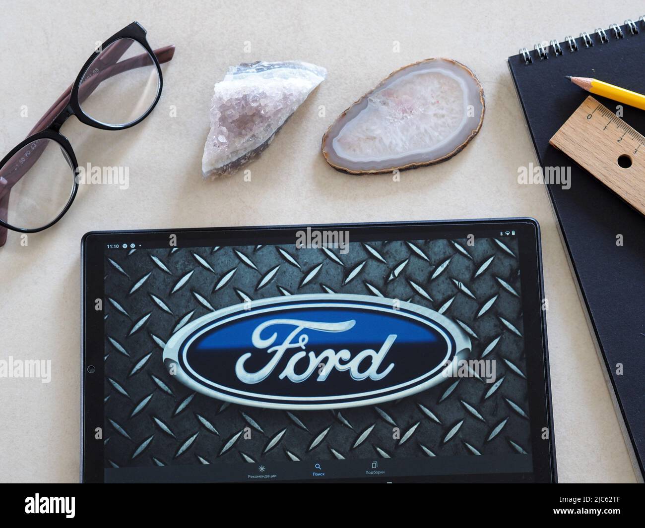 In this photo illustration, a Ford logo seen displayed on a tablet ...