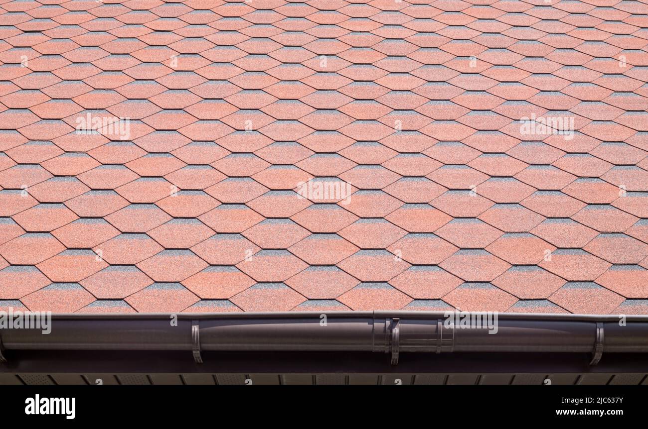 New roof with red shingles. Tiles on the roof of the house. Use to ...