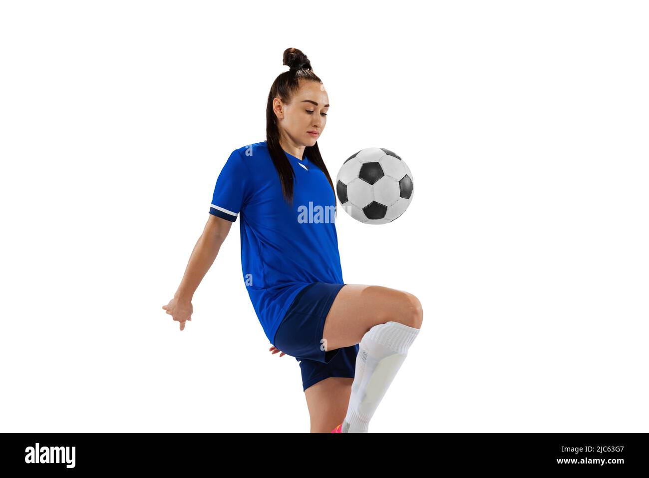 Studio shot of young female soccer, football player workout isolated on ...