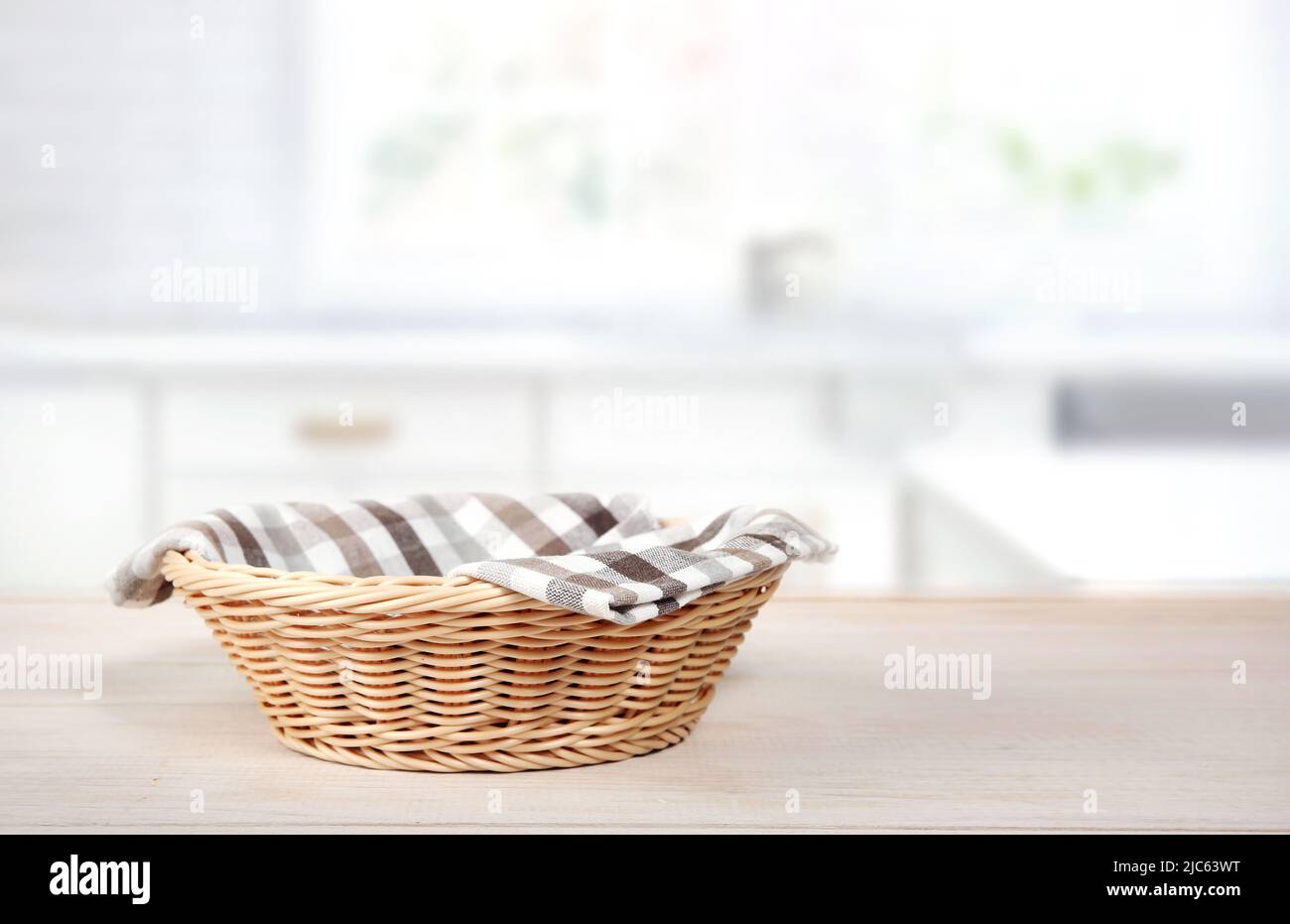 Straw empty basket on kitchen table.Food advertisement display ...