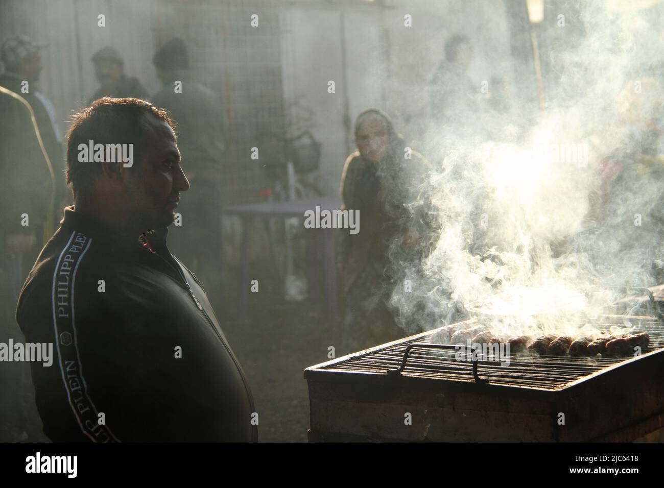 Farmers' market in a small village in Romania. Man preparing the ...